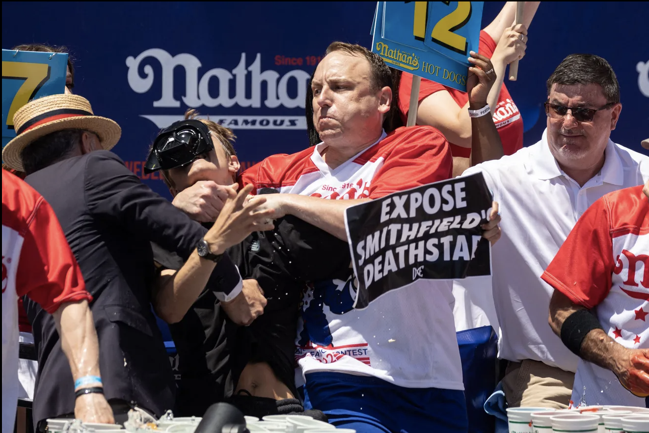 Joey Chestnut HEADLOCKS Animal Activist in Darth Vader Costume During ...